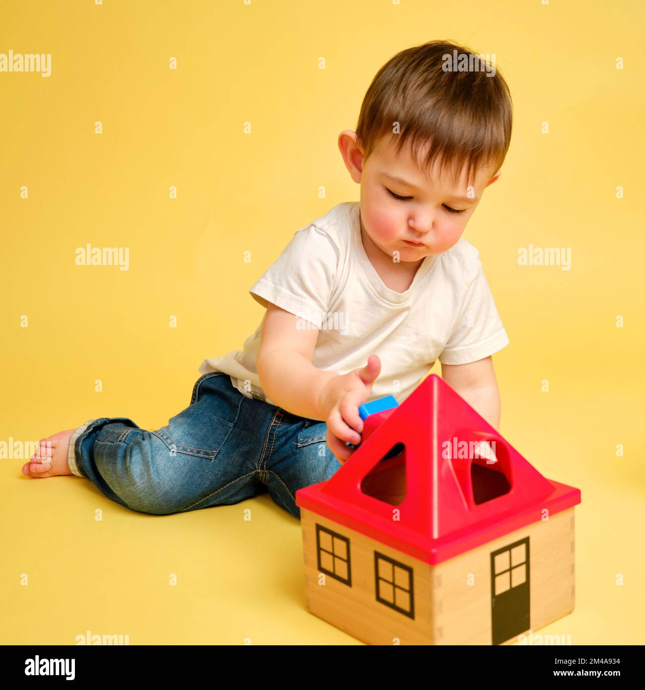 Toddler baby is playing sorter logic educational games with geometric ...