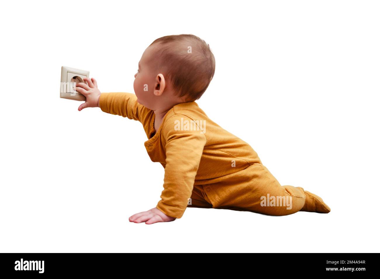 Baby toddler reaches into the electrical outlet on the home wall with ...