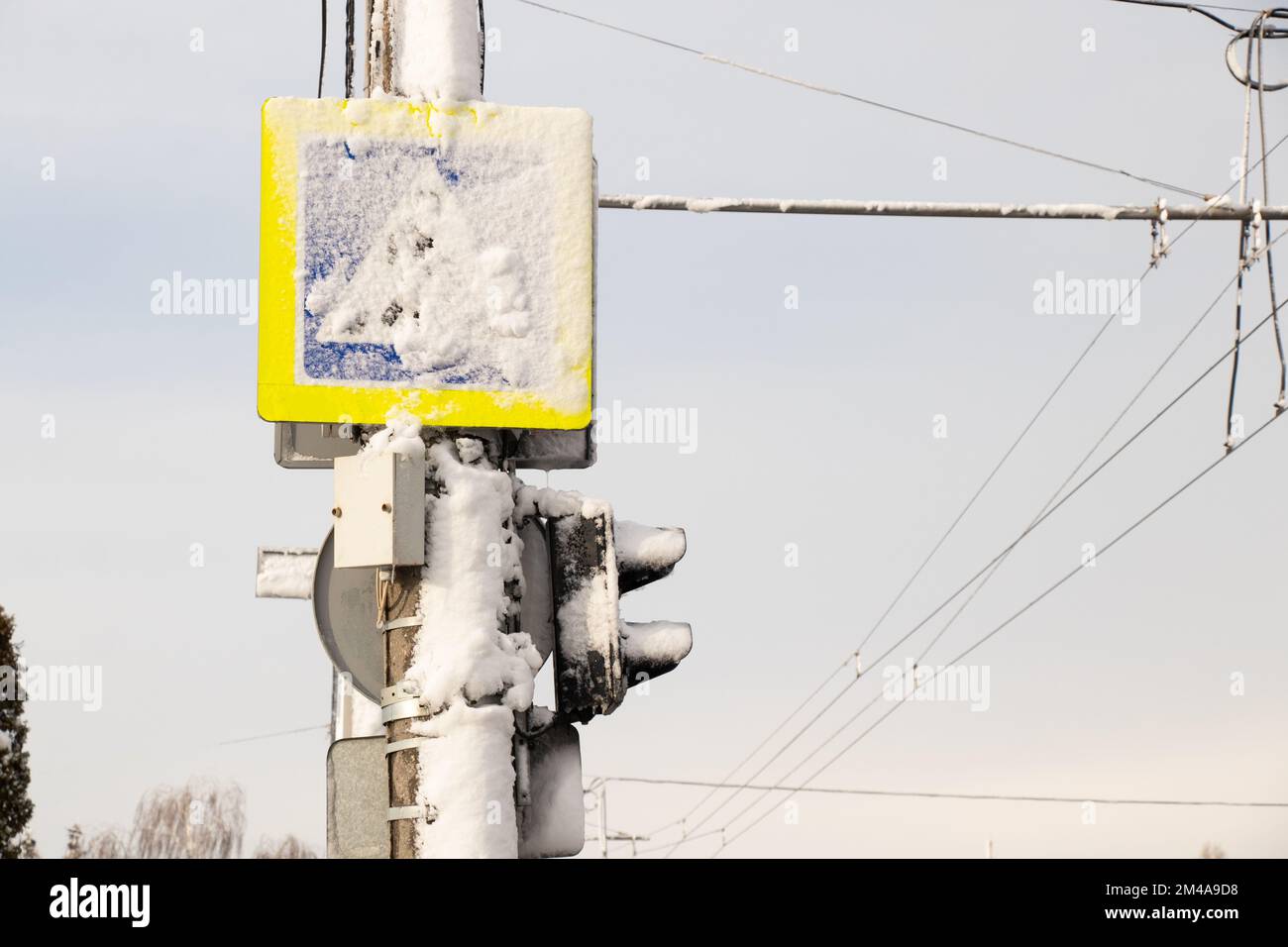 Traffic light and road sign in the snow in winter afternoon Stock Photo ...