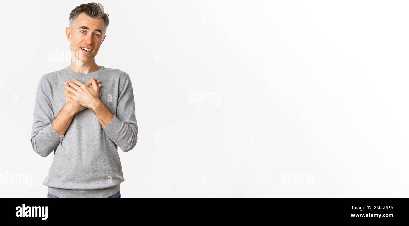 Image of pleased and happy adult man with gray hair, holding hands on ...