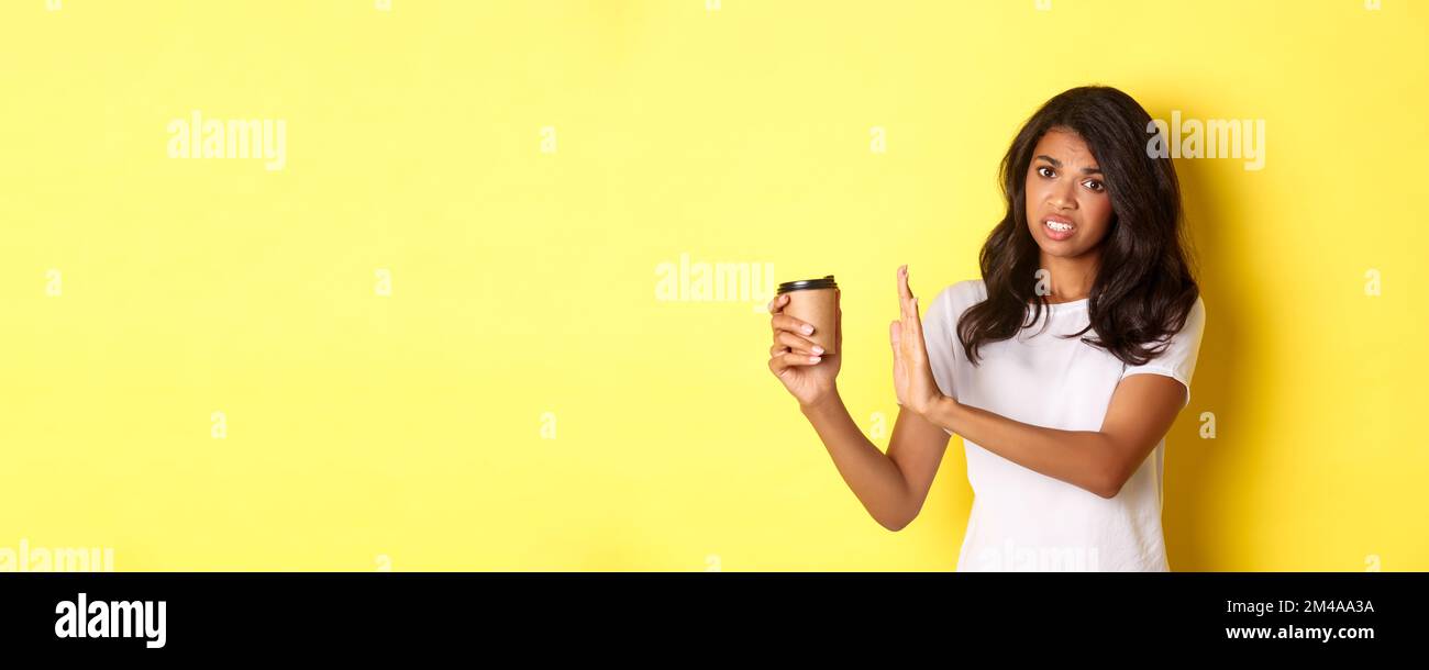 Image of african-american girl complaining about bad taste of coffee ...