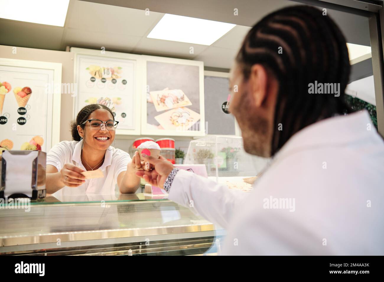 African worker serving an ice cream terrine to a client Stock Photo - Alamy