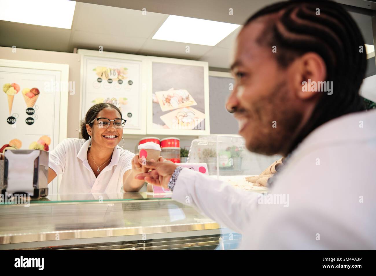 Friendly worker serving an ice cream terrine to a client Stock Photo ...