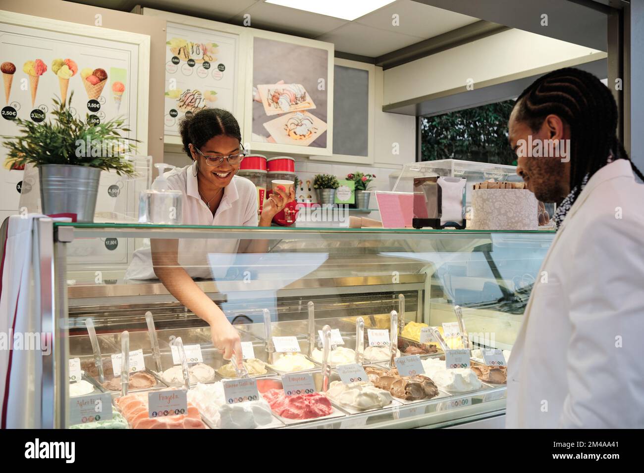 Worker serving a customer in an ice-cream shop Stock Photo - Alamy