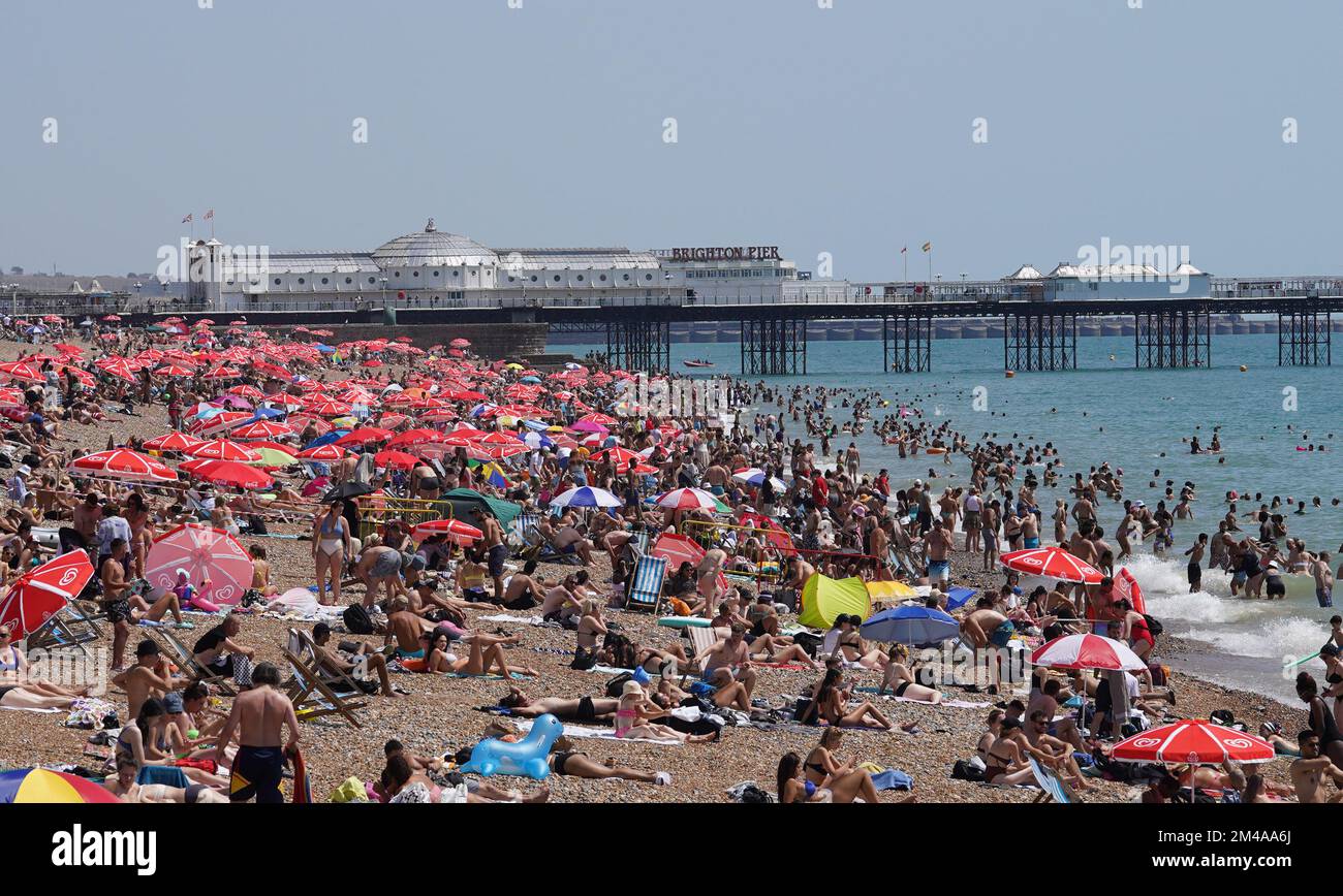 File photo dated 19/07/22 of people basking in the sun on a crowded ...