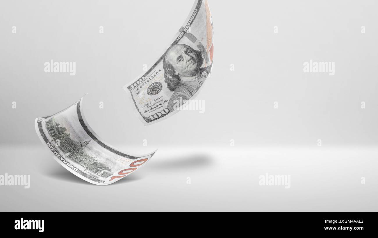 Flying dollars on gray background Stock Photo - Alamy