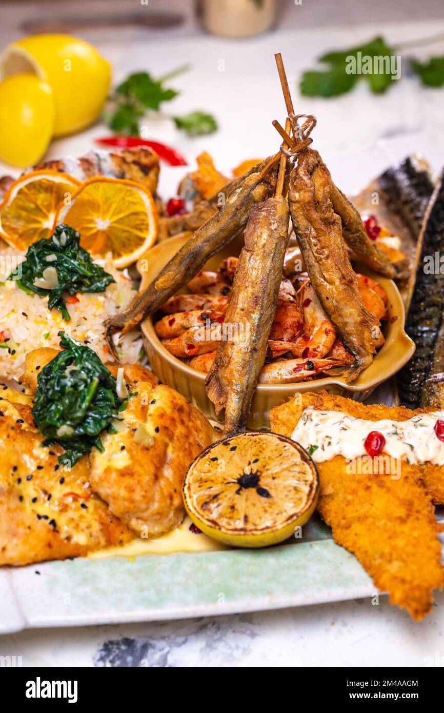 a set of different fish dishes on a white plate Stock Photo - Alamy