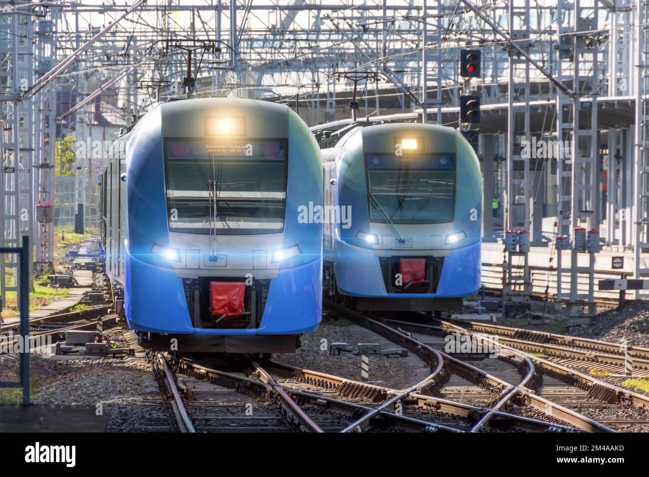 Two electric trains are traveling on parallel railway tracks with ...