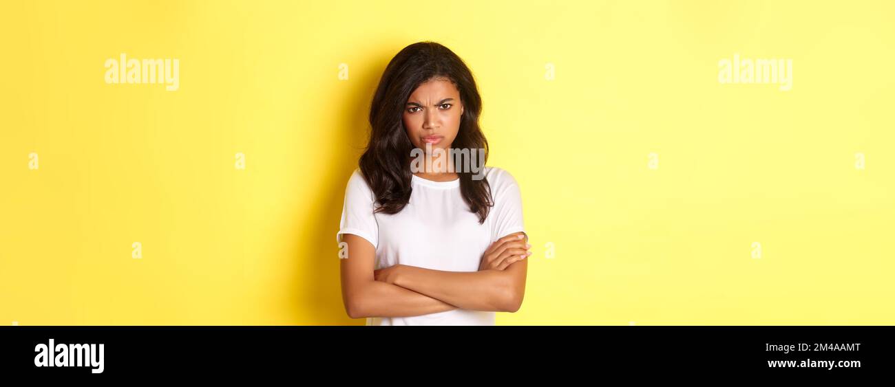 Image of cute african-american girl feeling angry, cross arms on chest ...