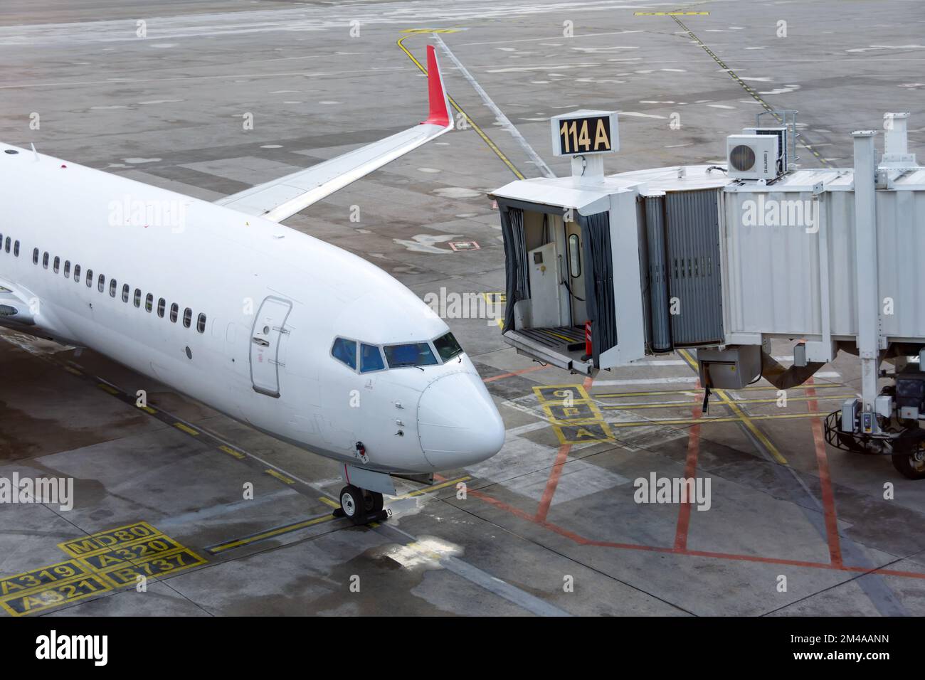 The aircraft is parked and the jet bridge is approaching the aircraft ...