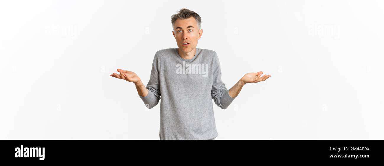 Image of confused middle-aged man shrugging shoulders, looking clueless ...
