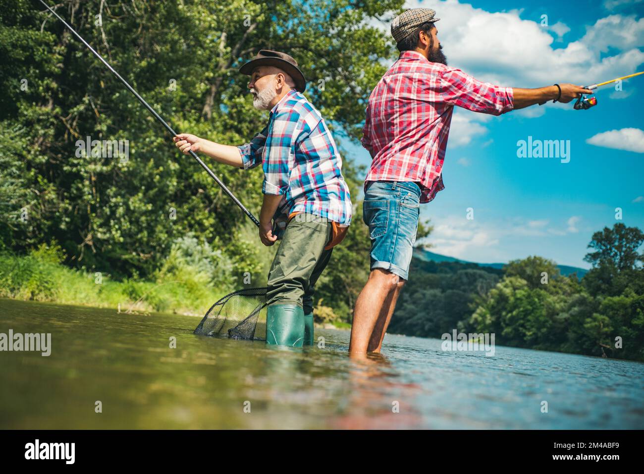 Fisherman men friends and trophy trout. Father and son fishing ...
