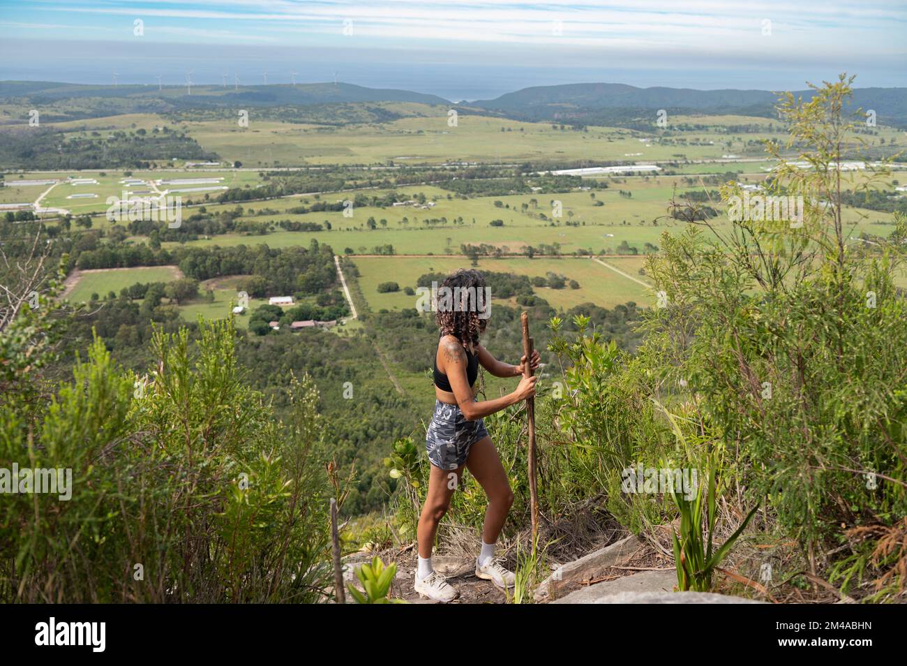 Person seen hiking and resting while looking back Stock Photo - Alamy