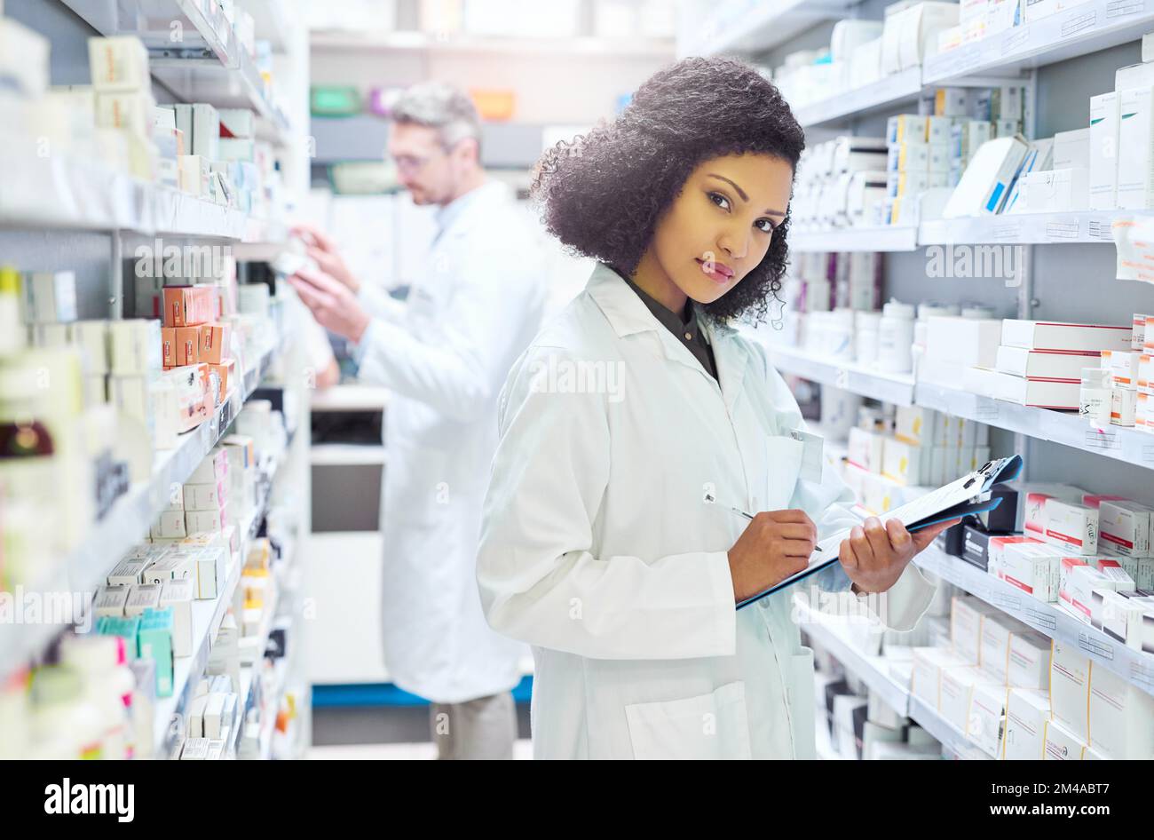 We stock only the best. a young woman doing inventory in a pharmacy ...