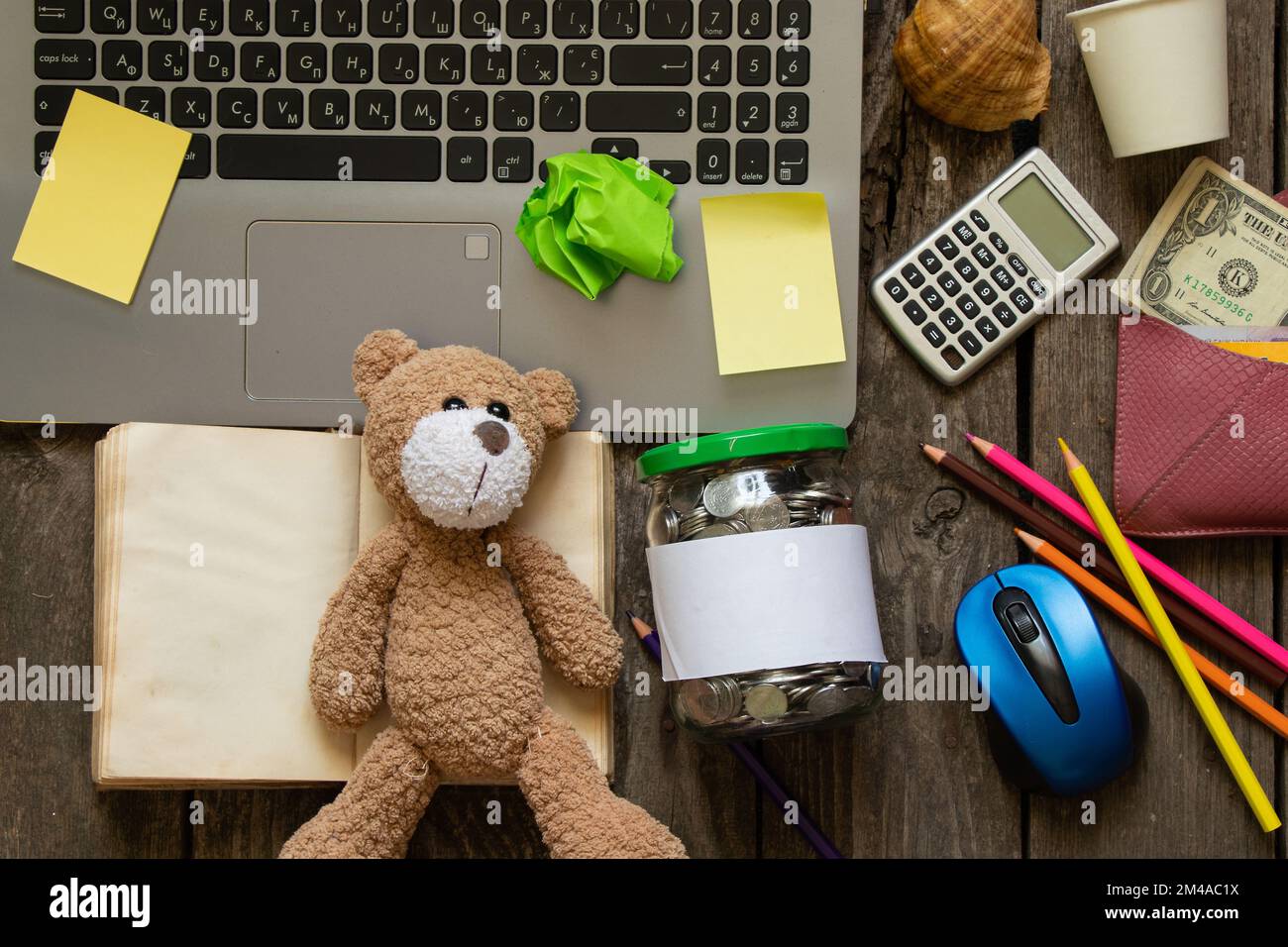 mess on the desktop laptop pencils and money paper Stock Photo - Alamy