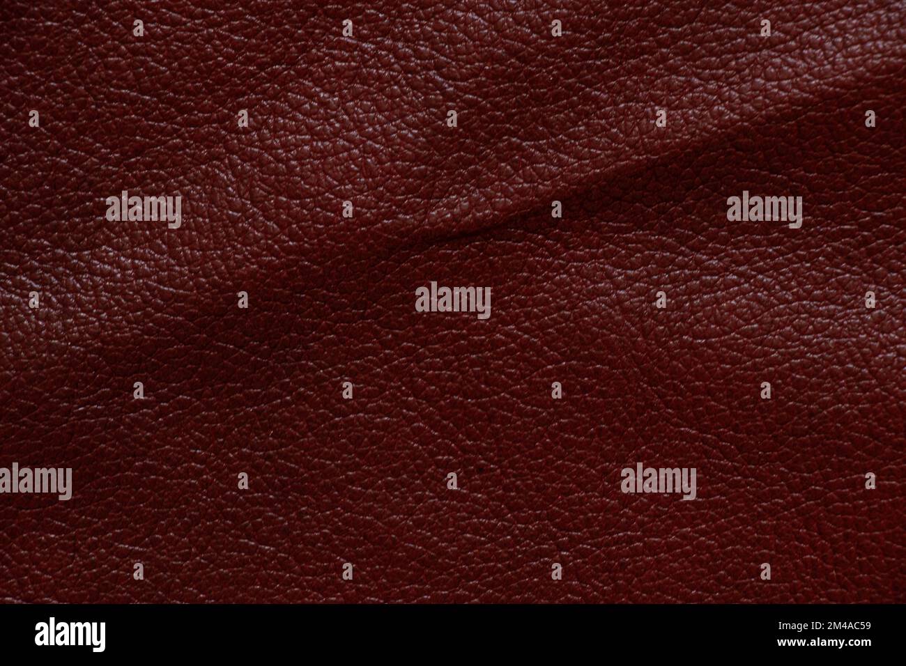 dark red genuine leather as a close up background Stock Photo - Alamy