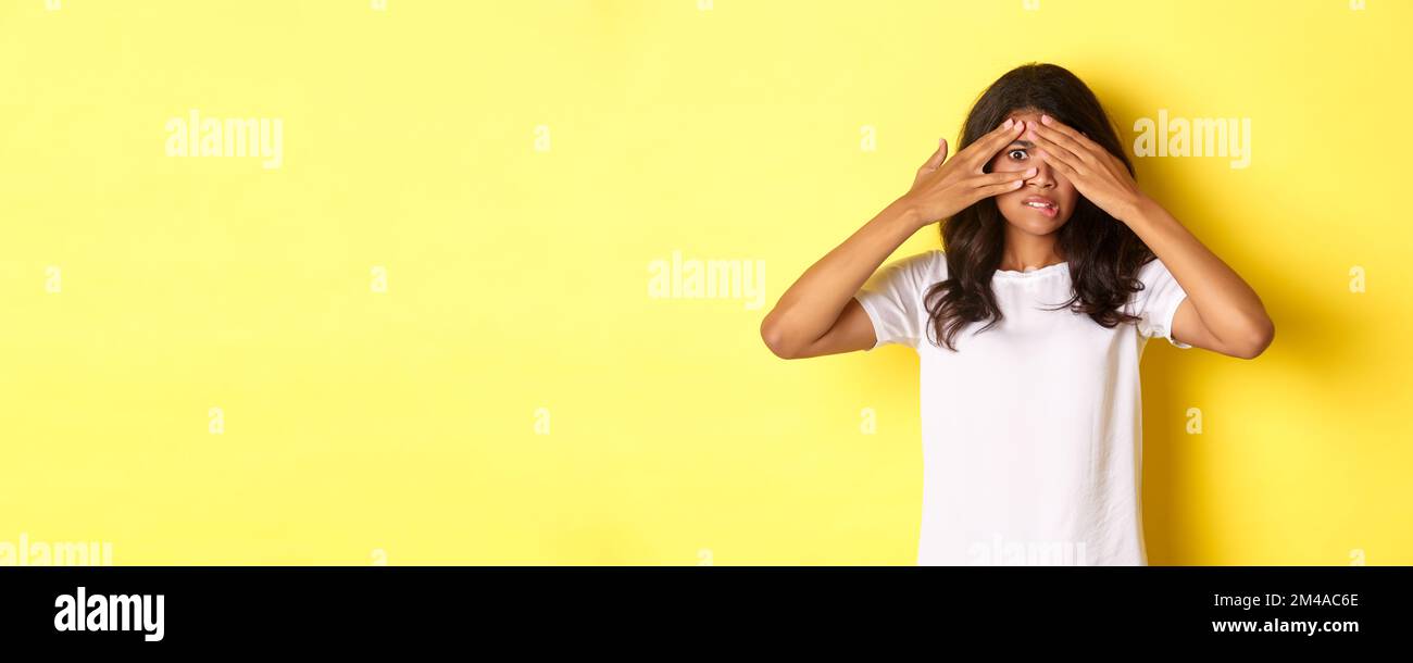 Portrait of embarrassed and shocked african-american girl, shut her ...