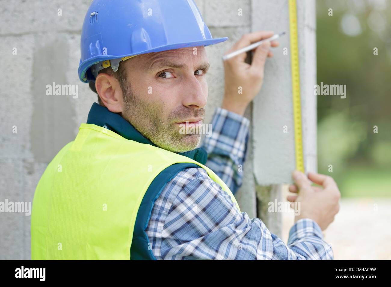 senior man measuring wall with construction level Stock Photo - Alamy