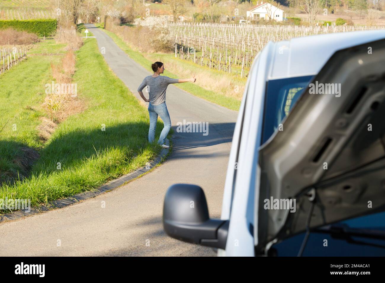 young woman hitch-hiking Stock Photo - Alamy