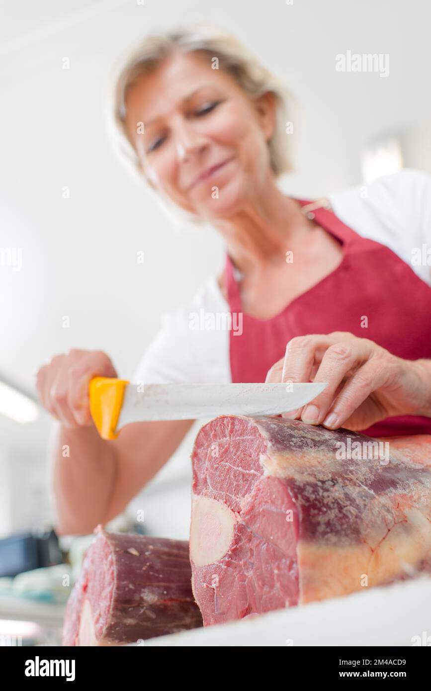 a female butcher slicing beef Stock Photo - Alamy