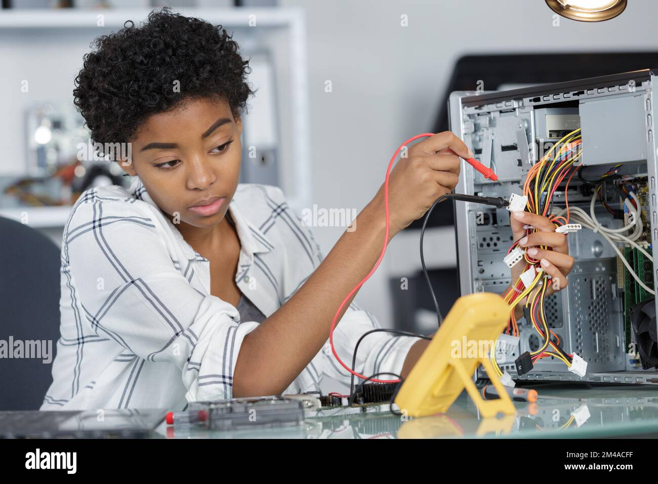 professional woman is fixing a computer Stock Photo - Alamy