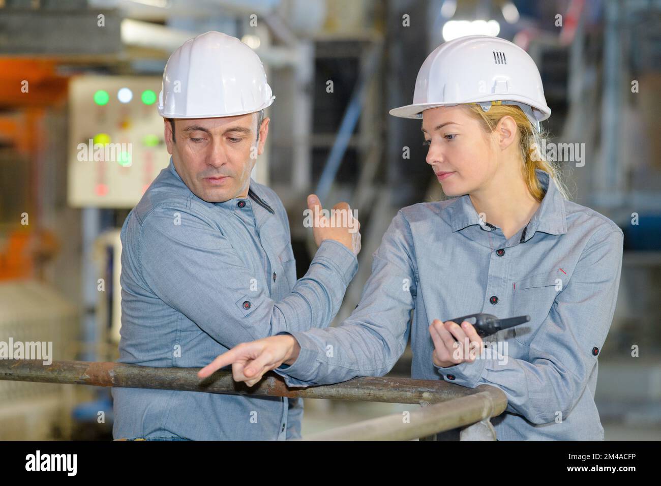 engineers looking down on to factory floor Stock Photo - Alamy