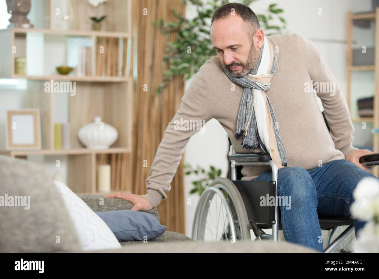 disabled man moving himself from a wheelchair Stock Photo - Alamy
