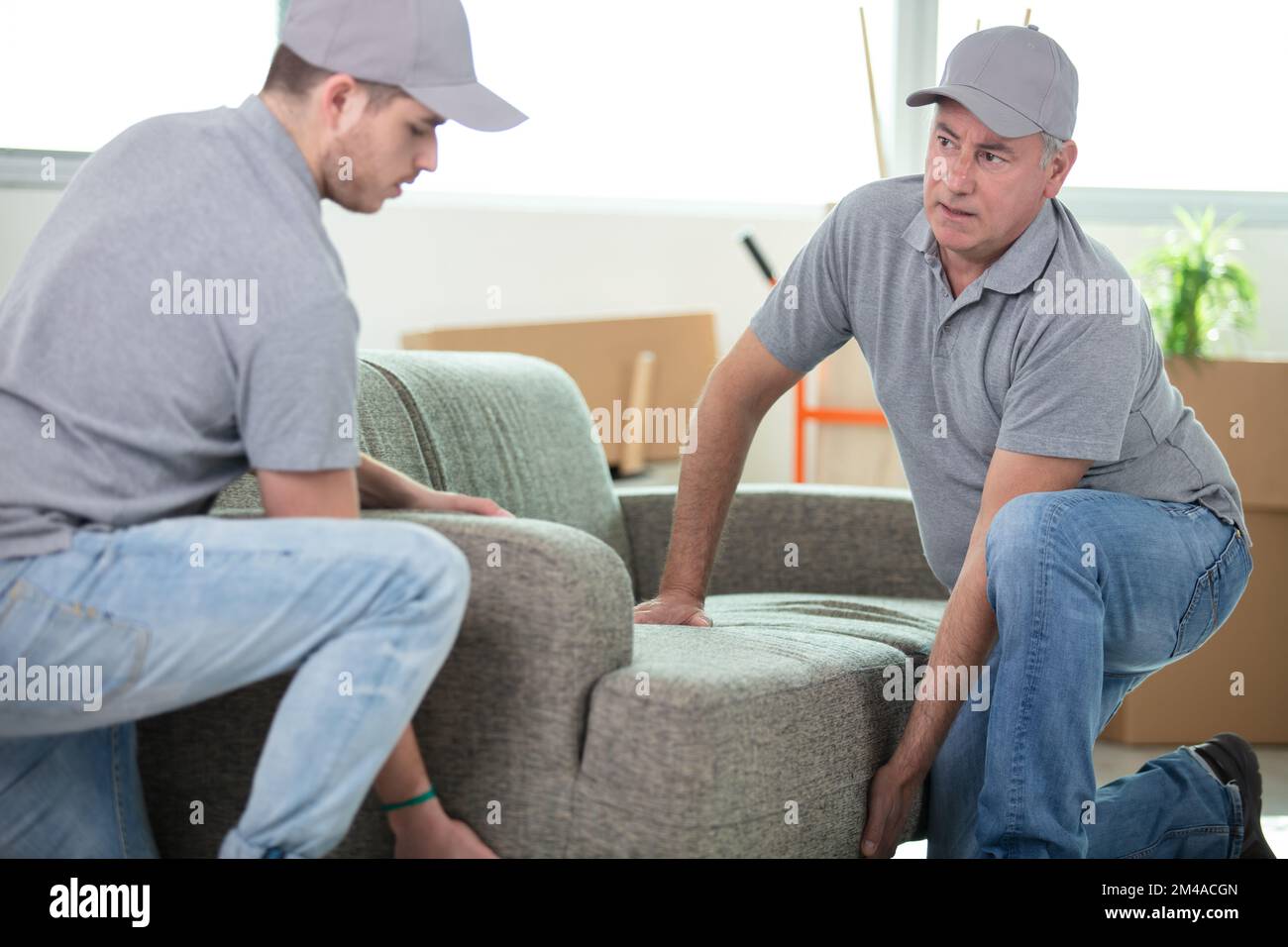 Movers moving sofa hi-res stock photography and images - Alamy