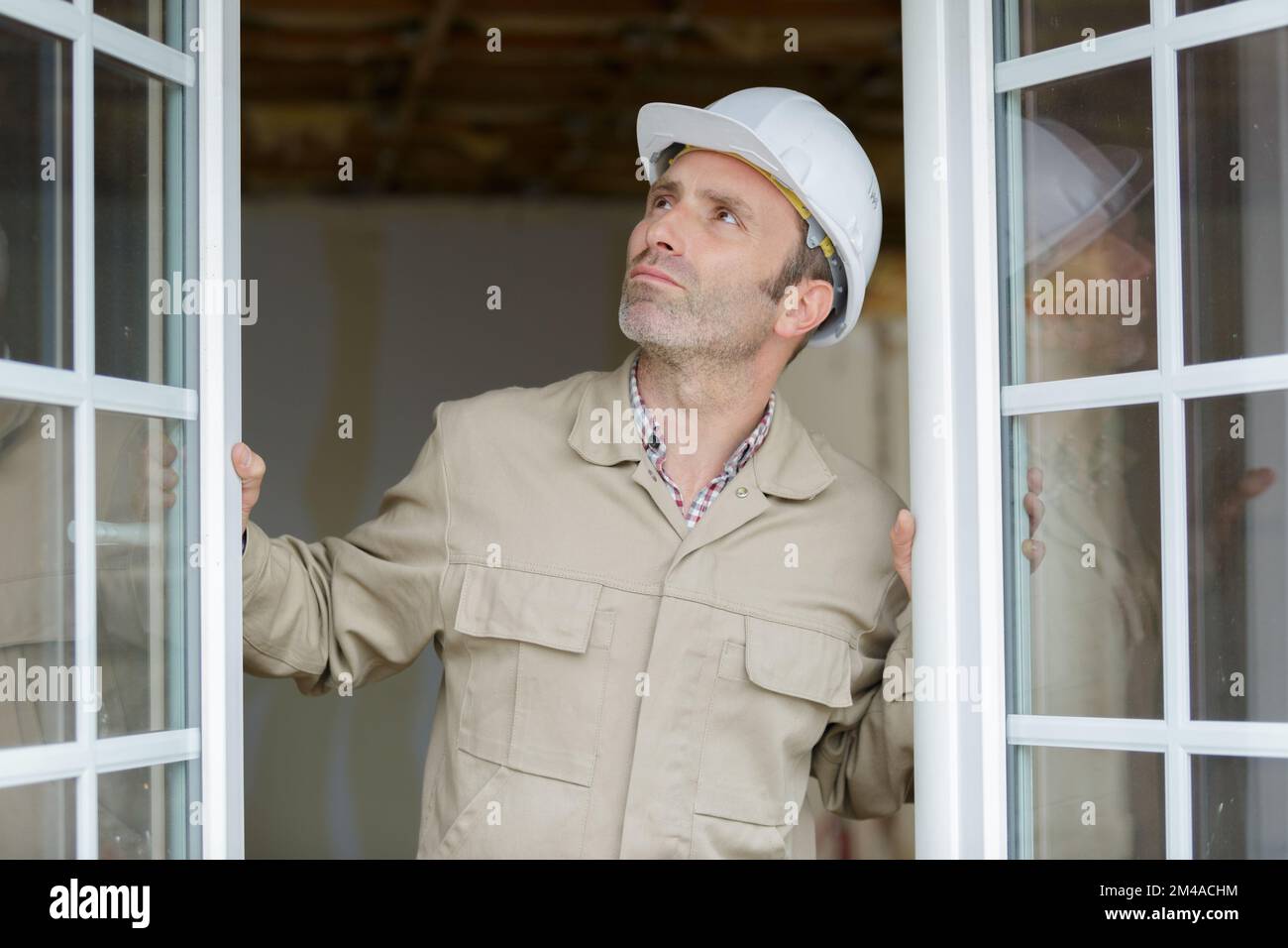 a window fitter checking installation Stock Photo - Alamy