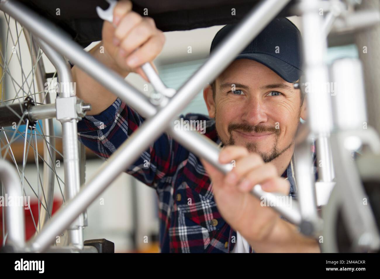 man assembling a wheelchair in a workshop Stock Photo - Alamy