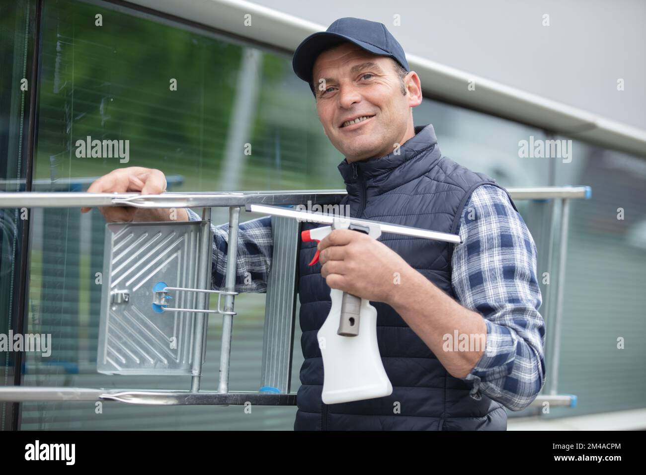 a man carries the ladder to clean the windows Stock Photo - Alamy