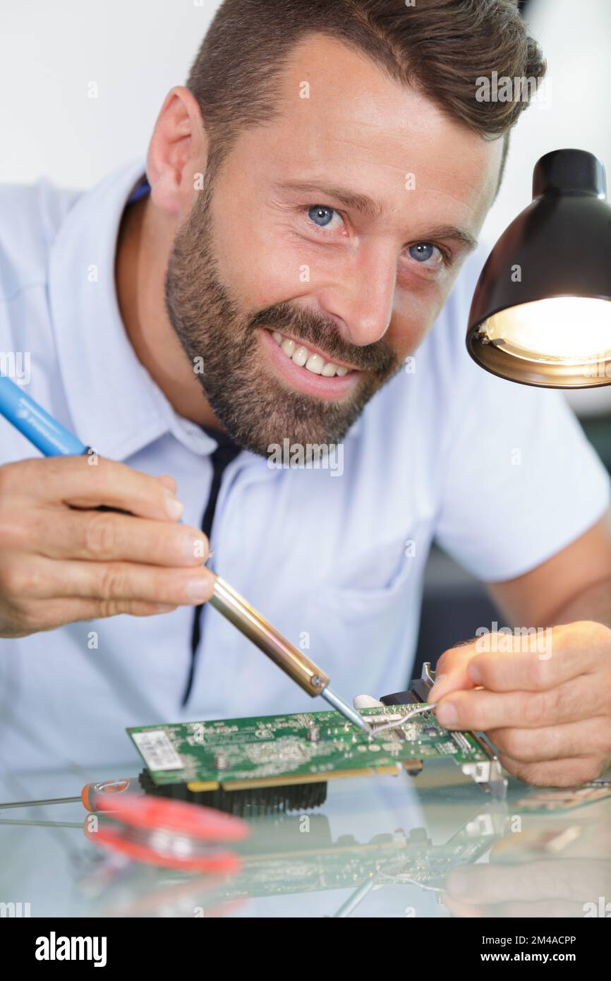 happy man chip soldering pc parts Stock Photo - Alamy