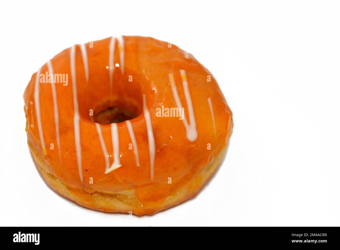 Mango flavored ring donut with white chocolate sauce, A glazed, yeast ...