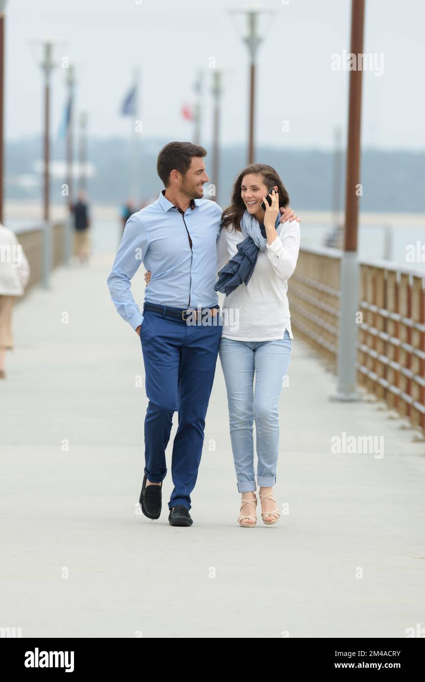 romantic couple walking on a pier Stock Photo - Alamy