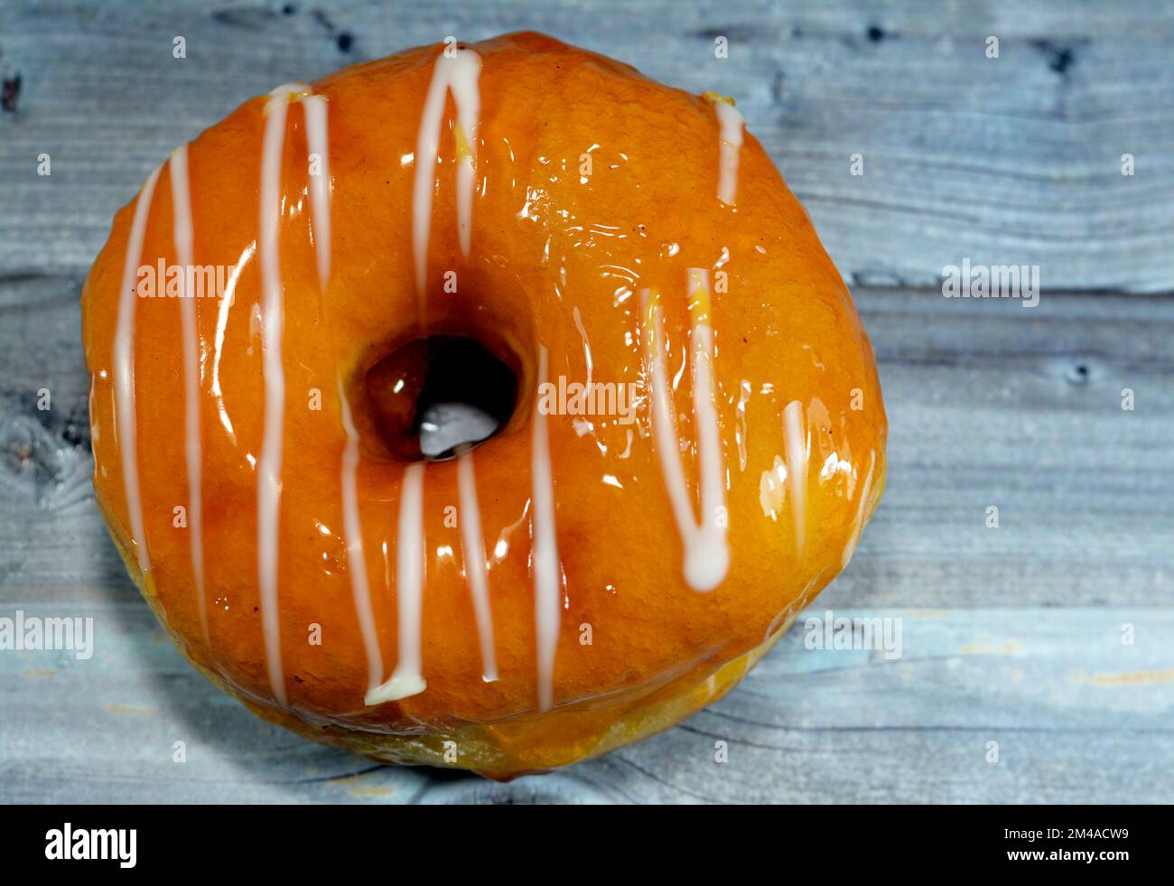 Mango flavored ring donut with white chocolate sauce, A glazed, yeast ...