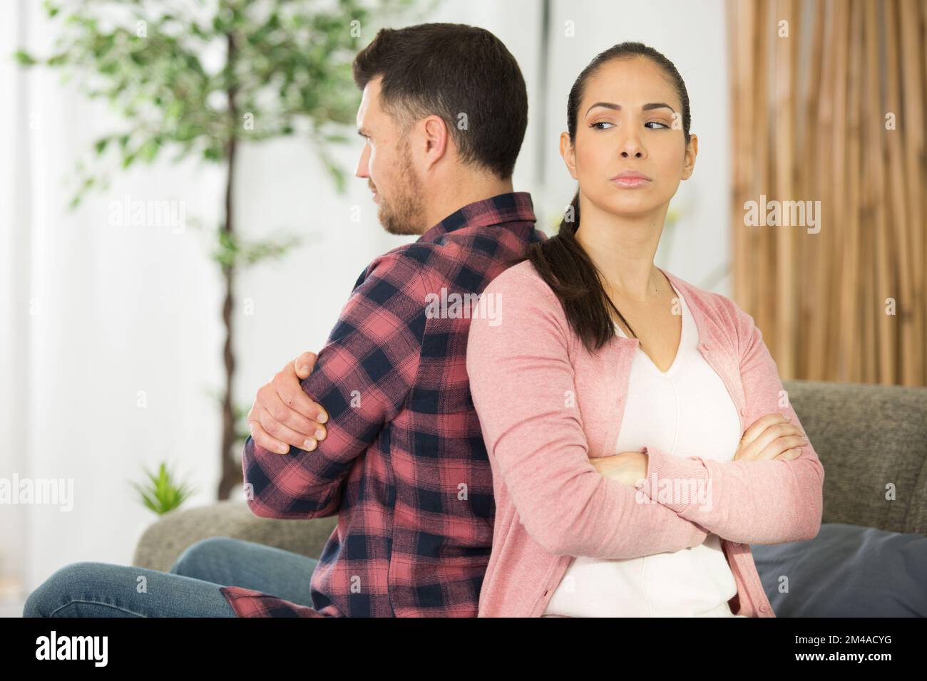 couple back-to-back ignoring eachother after an argument Stock Photo ...