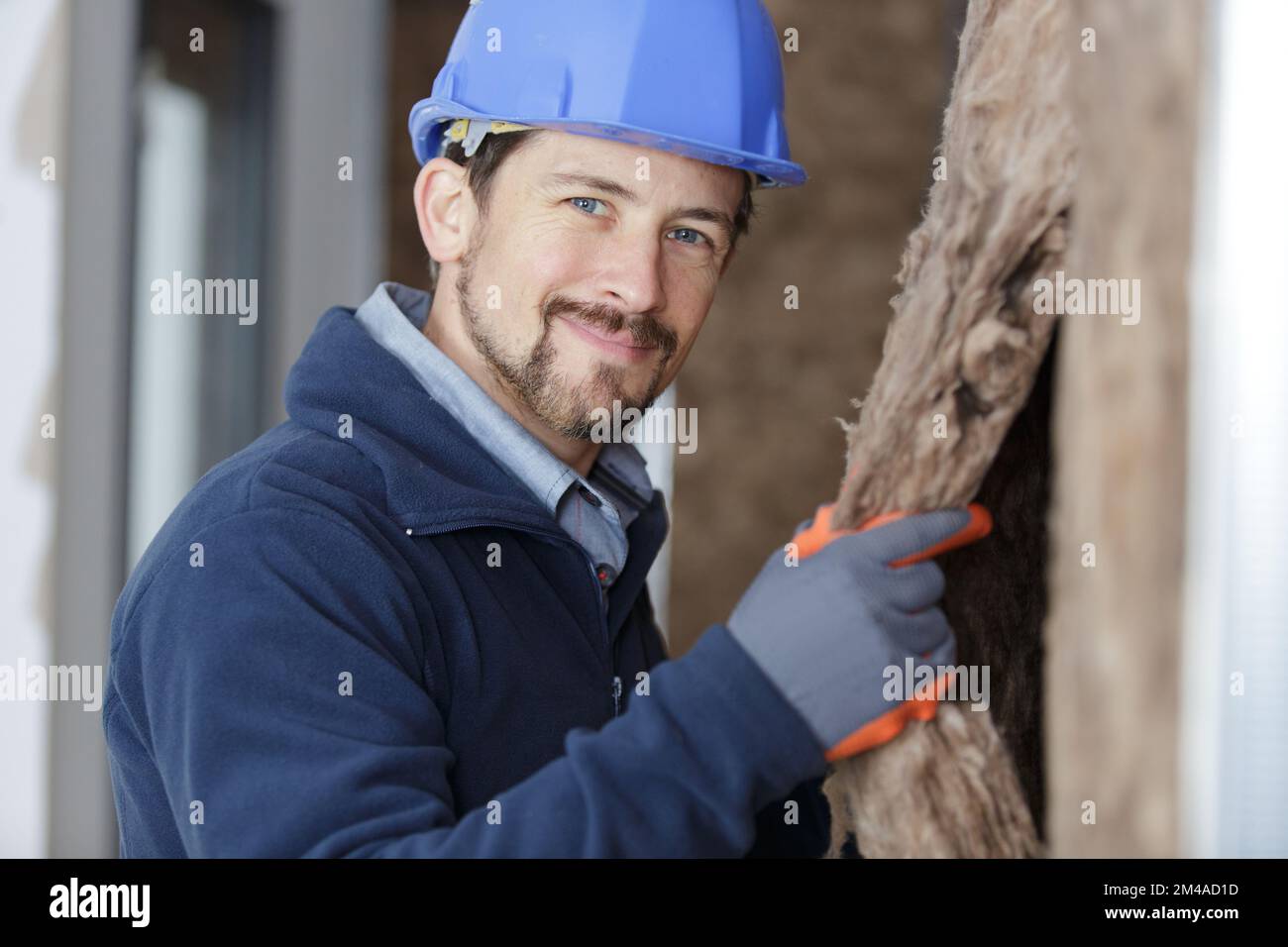 young handsome construction worker indoors Stock Photo - Alamy