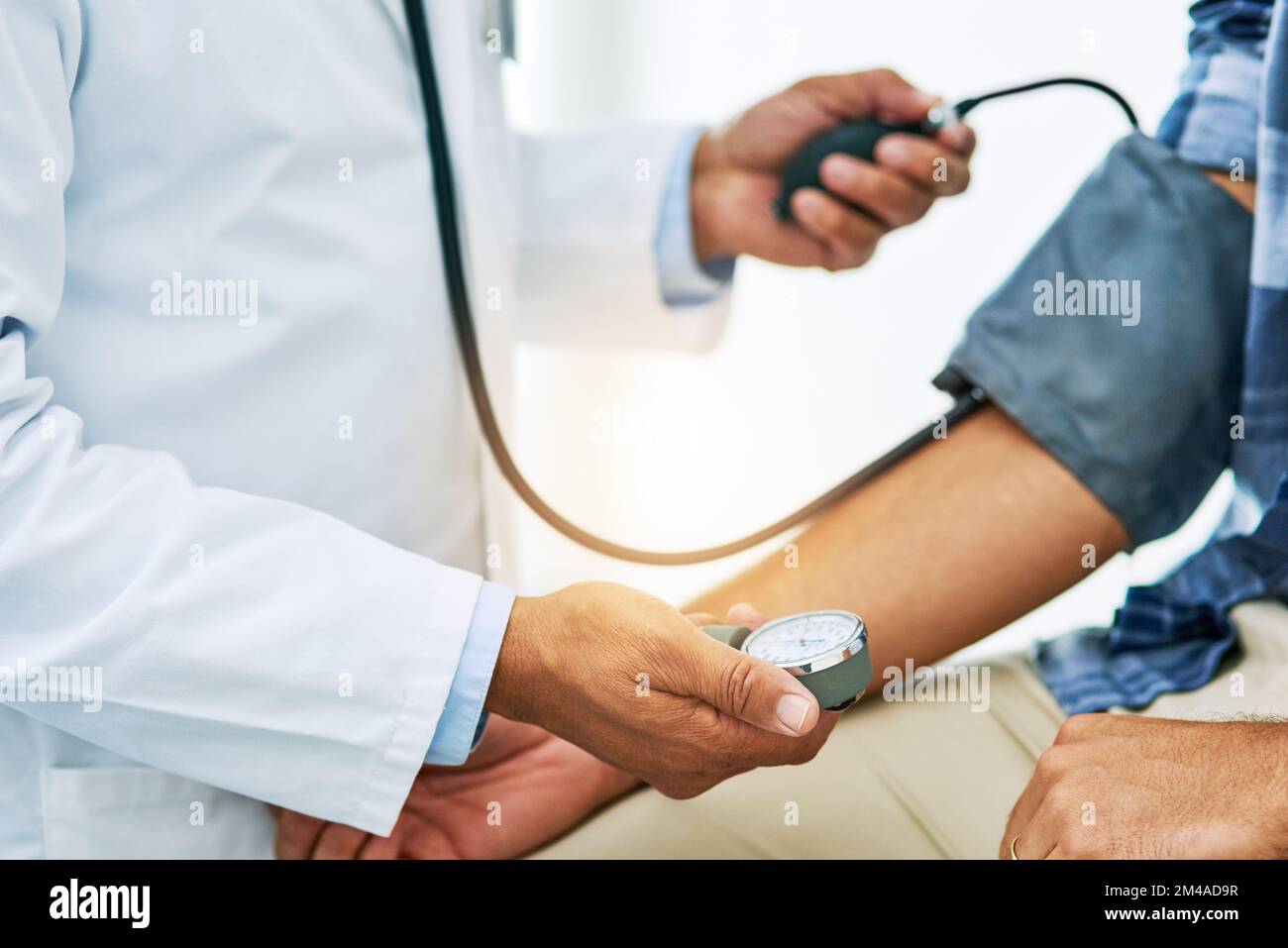 Take a few deep breaths. an unrecognizable male doctor running tests on ...