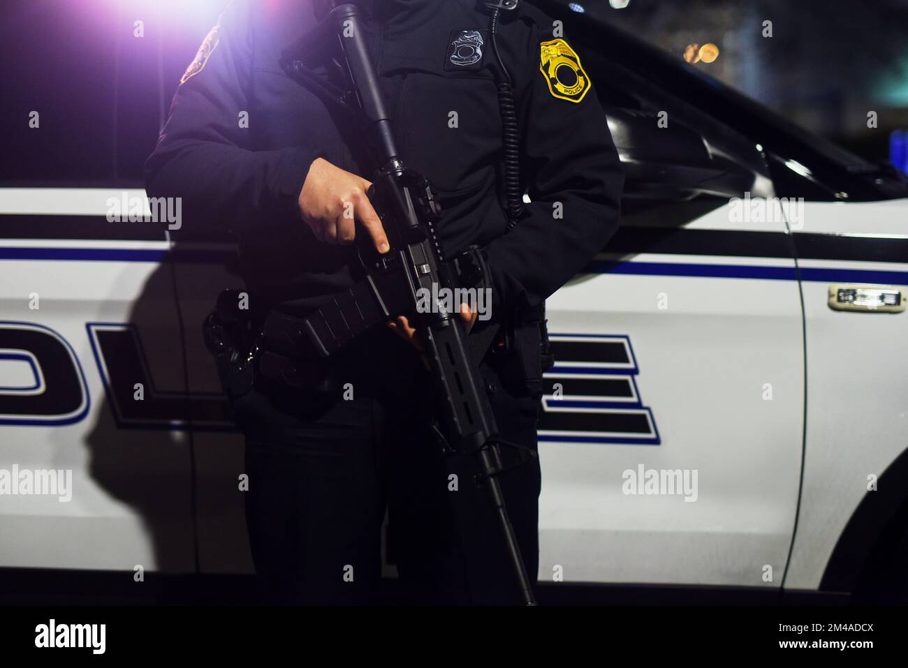 Hes packing some serious heat. an unrecognizable policeman standing ...