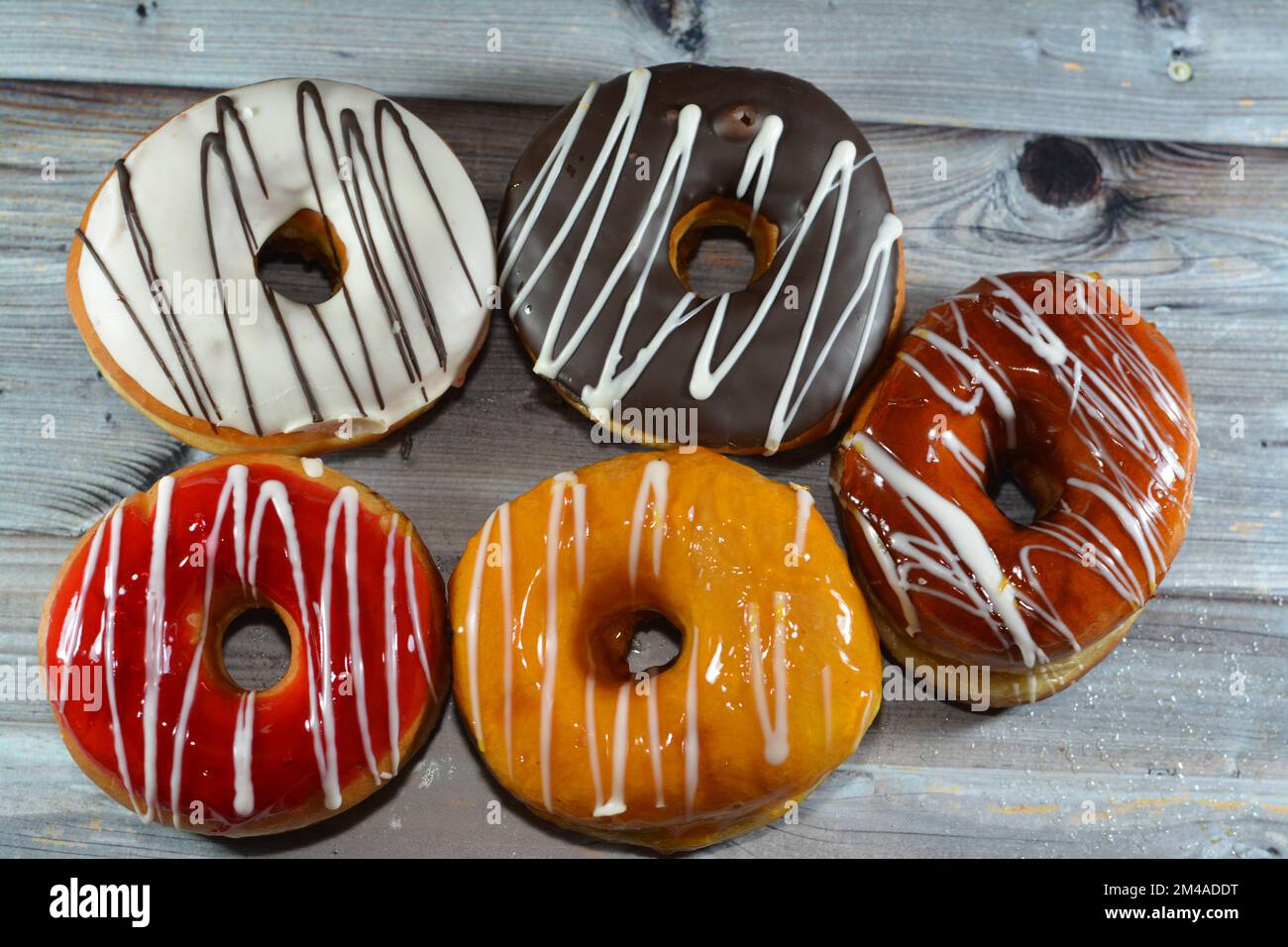 Ring donuts with brown and white chocolate and caramel, strawberry and ...