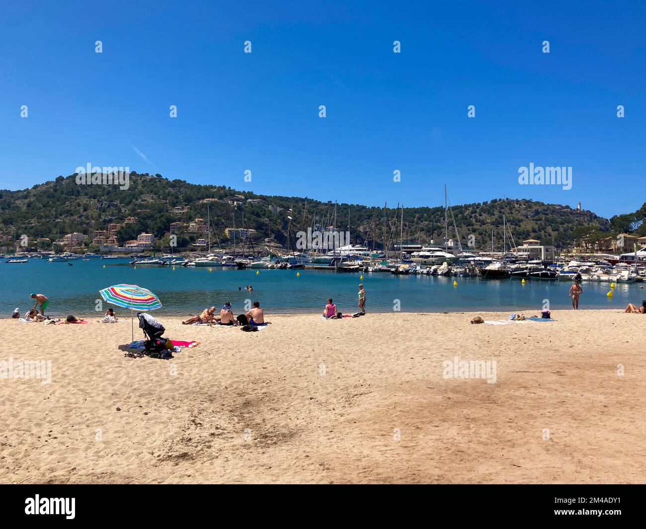 A scenic shot of the Cala Formentor beach in Mallorca and people ...