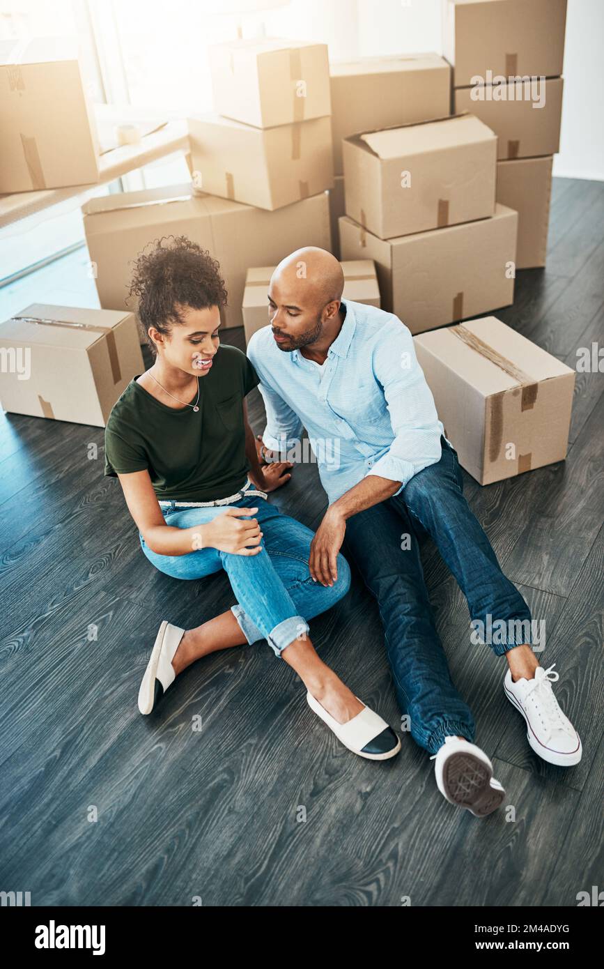 Its been a long day of moving boxes around. a young couple taking a ...