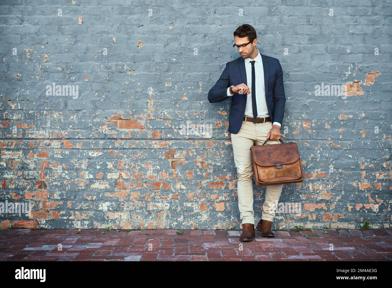 Time marches on. Full length shot of a handsome young businessman ...