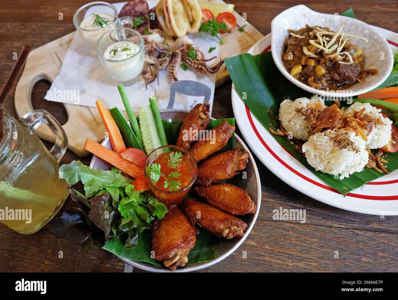 Fried sticky rice served with northern Thai curry, chicken wings and ...