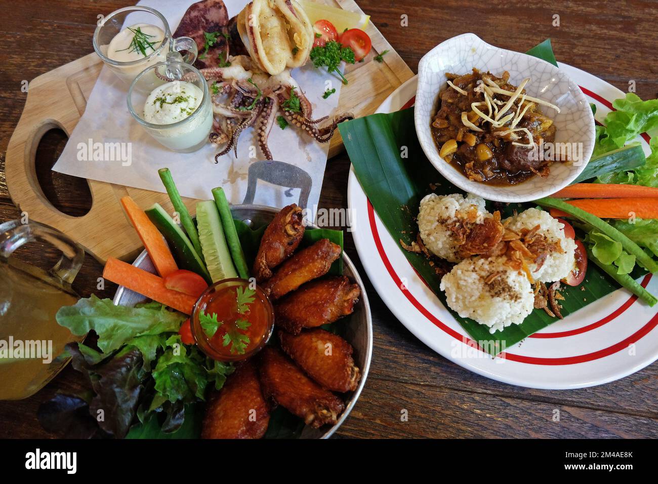 Fried sticky rice served with northern Thai curry, chicken wings and ...