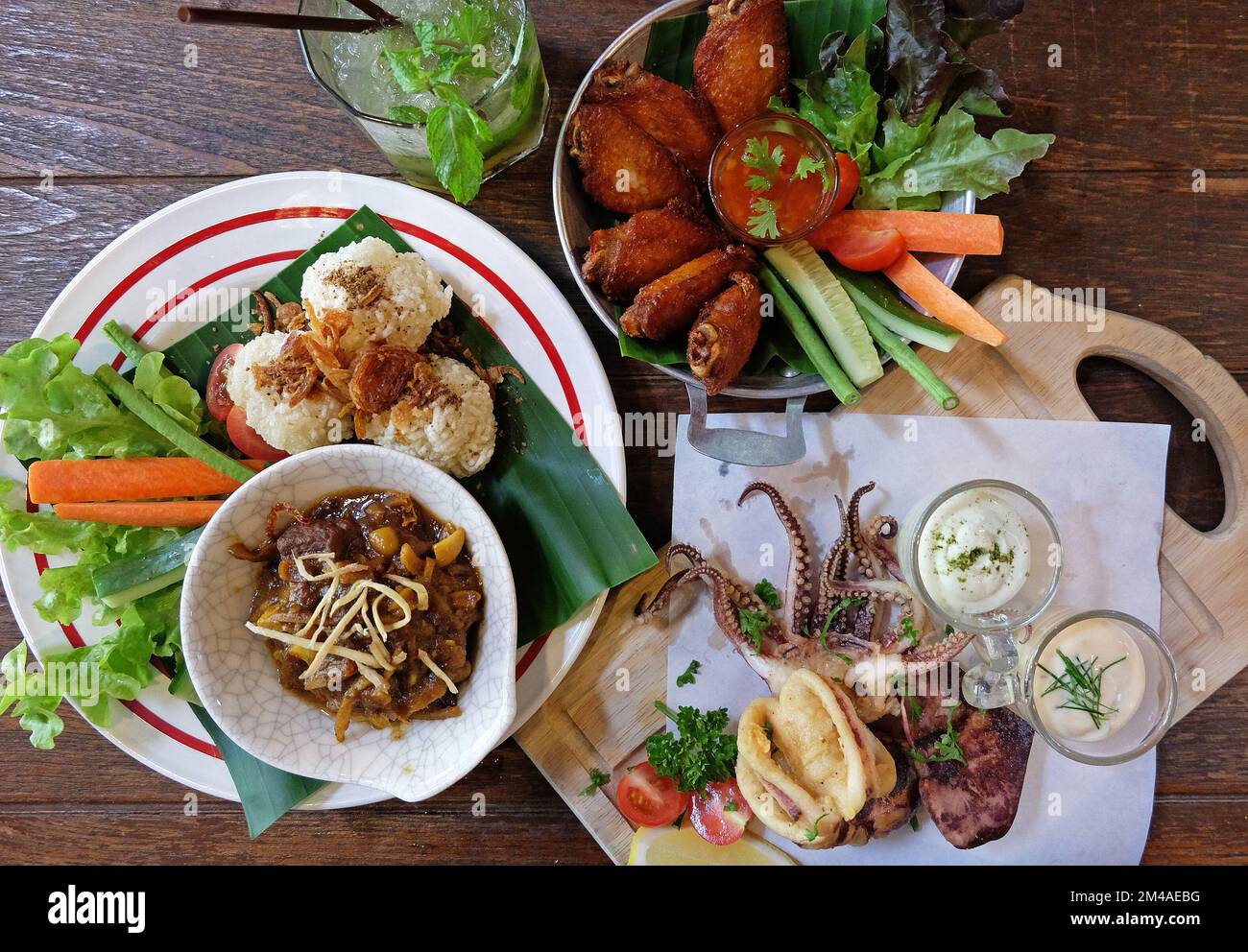 Fried sticky rice served with northern Thai curry, chicken wings and ...