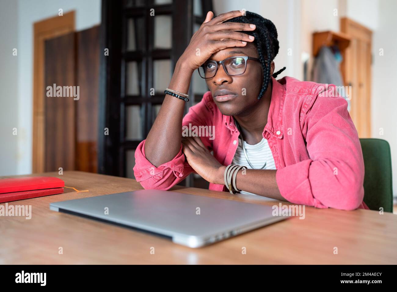 Depressed sad young African student guy feeling lazy and unmotivated to ...