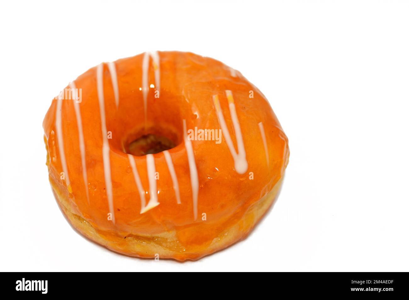 Mango flavored ring donut with white chocolate sauce, A glazed, yeast ...