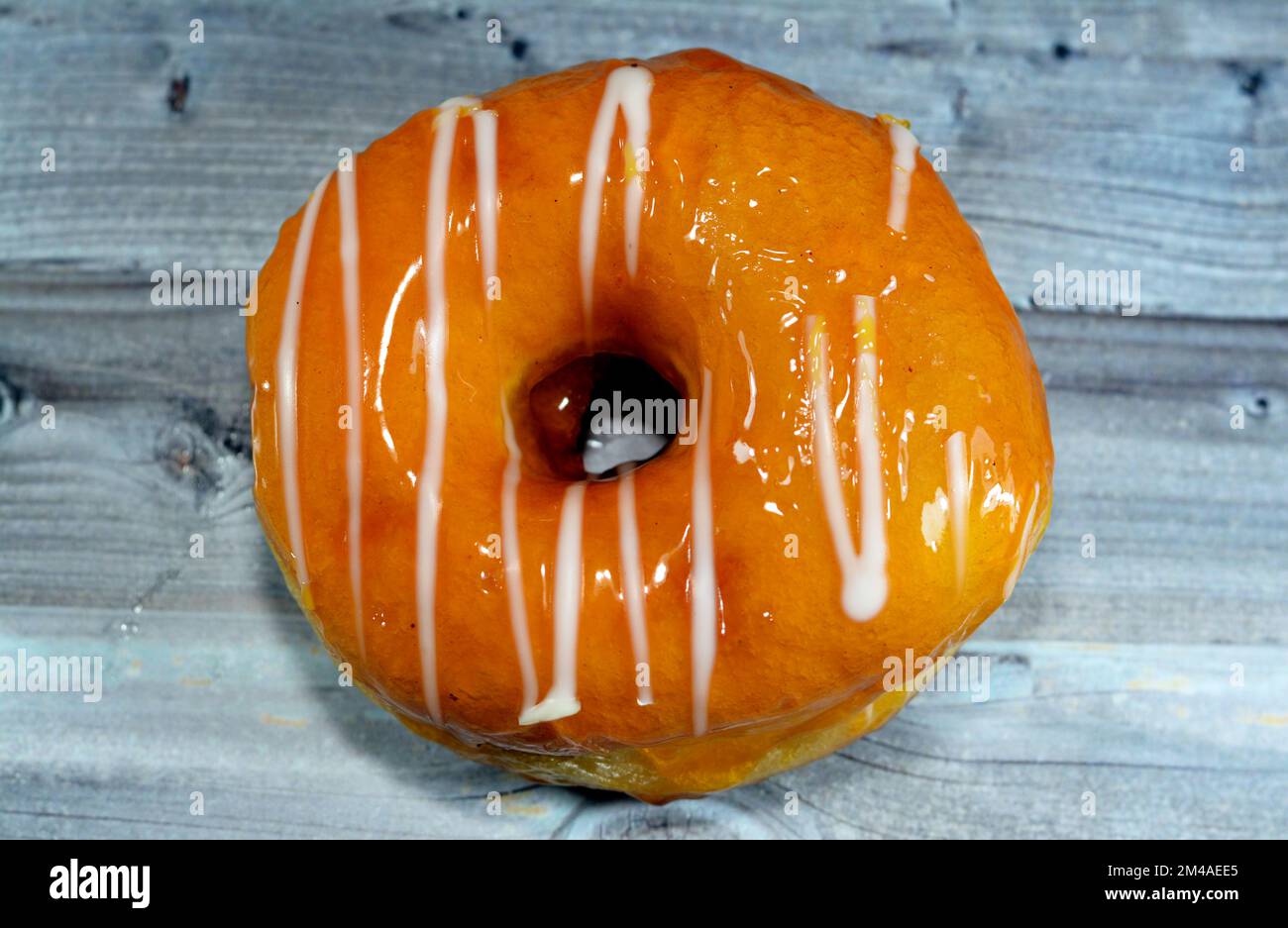 Mango flavored ring donut with white chocolate sauce, A glazed, yeast ...