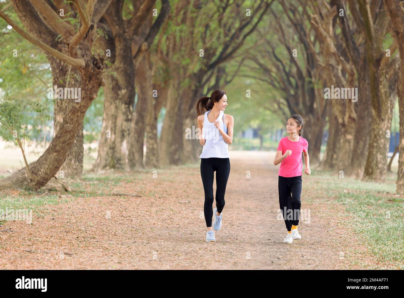 Happy Mother and daughter running in the park Stock Photo - Alamy